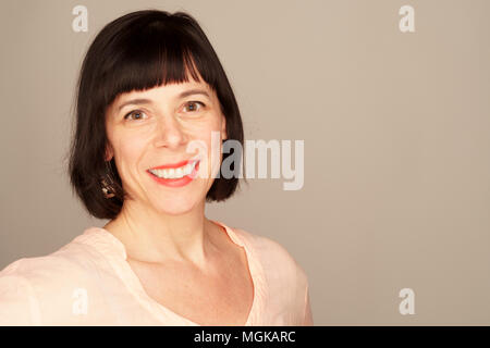 Portrait of attractive cheerful minded brown-haired girl thinking copy ...
