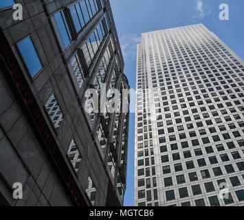 Abstract reflections of buildings in the curved green glass façade of ...