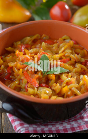 Lecso in a pot on a rustic table Stock Photo - Alamy