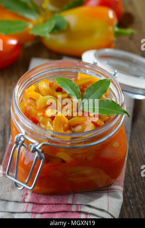 Lecso in a jar on a rustic table Stock Photo - Alamy