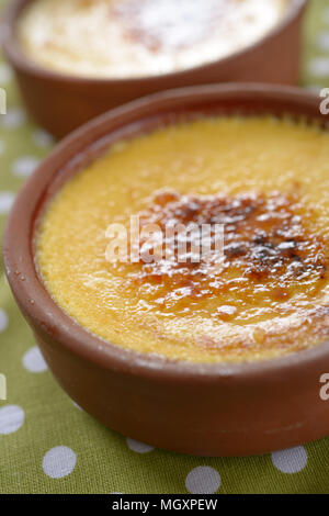 Crema catalana, Spanish dessert in three ramekin on blue table, copy ...
