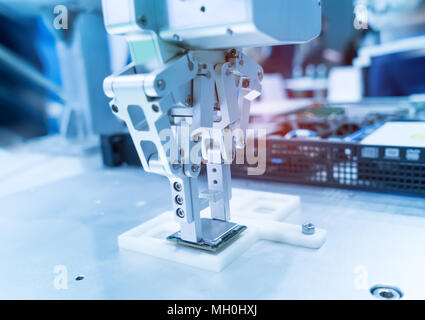 Industrial robot installing a computer chip at production line in ...