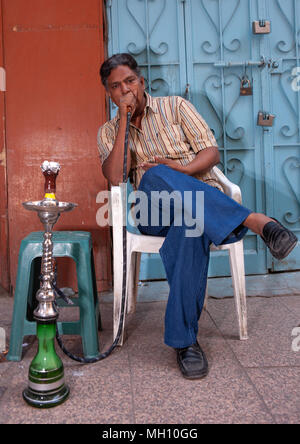 Saudi man smoking in the street, Najran Province, Najran, Saudi Arabia ...