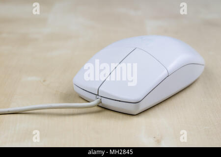 Old computer mouse running on the principle of a ball on a wooden table ...