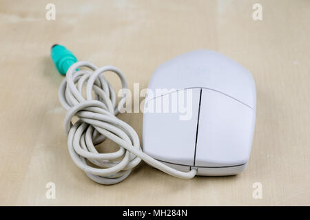 Old computer mouse running on the principle of a ball on a wooden table ...