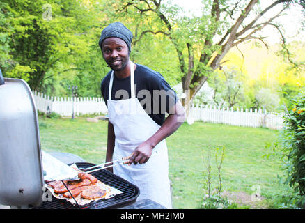 A cheerful man grills outdoors in the park Stock Photo - Alamy