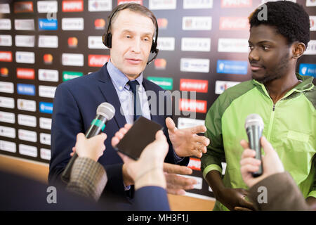 African American man giving presentation to colleagues at international ...