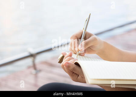 Writing dairy on notebook in coffee shop, concept as memory of life and ...