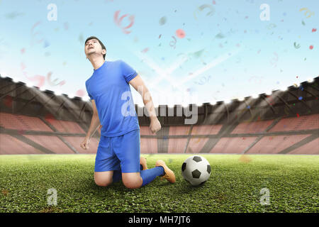 Happiness asian soccer player with excited expression Stock Photo - Alamy