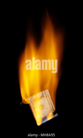 Burning money 5 dollar on fire Stock Photo - Alamy