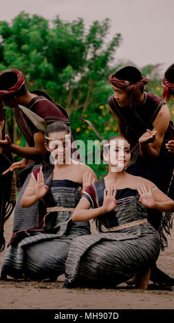 Portrait of happy smiling Batak children peeking out of hole in ...