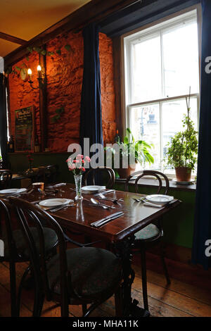 Details inside an empty small restaurant with tables laid out with ...