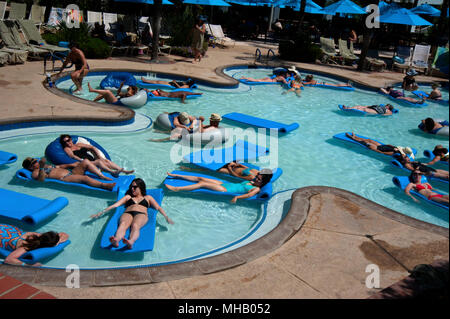 People floating on rafts in mineral hot springs pool at Glen Ivy Hot ...