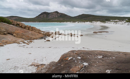 White beach of Thistle Cove on an overcast day, one of the most ...