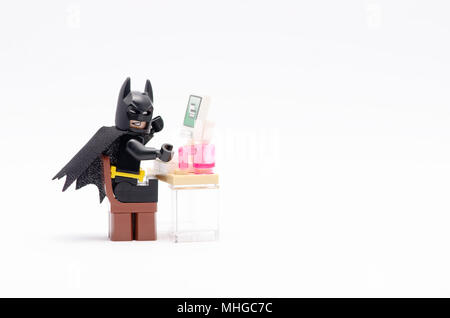 mini figure of batman on chair in front computer. Lego minifigures are ...