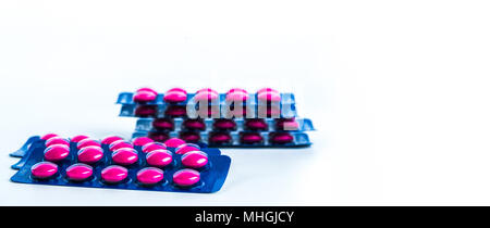 Ibuprofen in pink tablet pills pack in blue blister pack isolated on ...