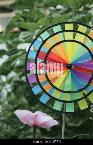 Colorful rainbow pinwheel wind spinner with polka dot pattern on a ...