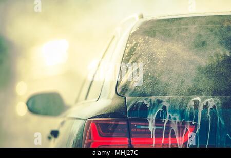SUV covered in a car wash detergent isolated on white background Stock ...