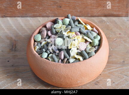 hamster food in pottery on wooden table Stock Photo - Alamy