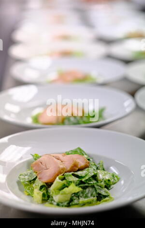 student preparing meals for their graduation guests at a cooking school ...