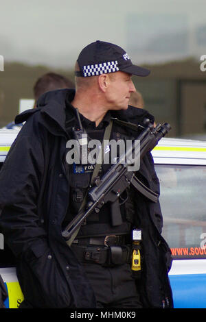 An Authorised Firearms Officer or AFO of the British police holding a ...