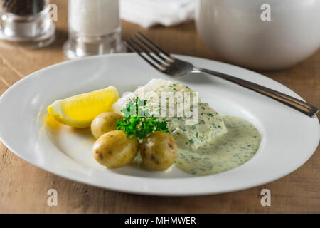 Cod in parsley sauce Stock Photo - Alamy