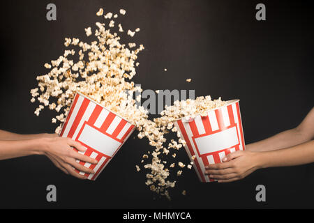 people spilling out popcorn from buckets Stock Photo - Alamy