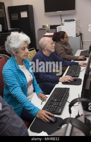 Seniors at a senior citizen center take a computer class in lower ...