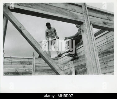 Snapshot of men laying wood for a building structure Stock Photo - Alamy