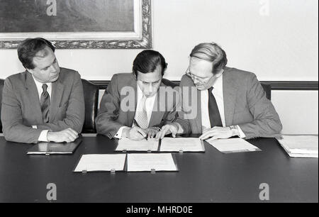 Snapshot of men signing documents Stock Photo - Alamy