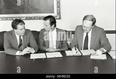 Snapshot of men signing documents Stock Photo - Alamy