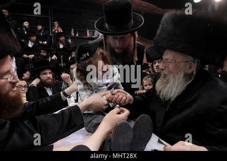 A 3 year old religious Jewish boy getting his first haircut at a ritual ...