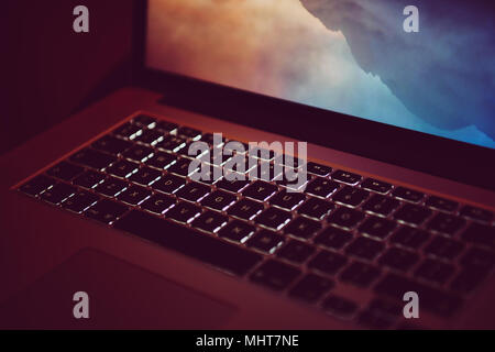 Laptop with white screen glowing in the dark at home from above Stock ...