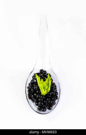 Plastic spoons with fish caviar on a white background Stock Photo - Alamy