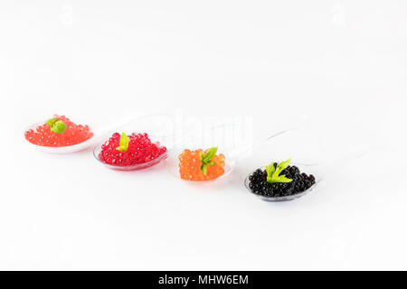 Plastic spoons with fish caviar on a white background Stock Photo - Alamy