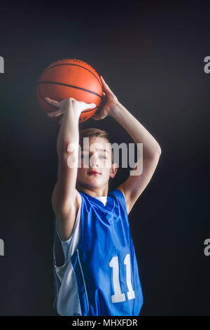Boy throwing a basketball Stock Photo - Alamy