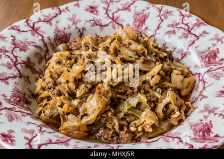 Turkish Cabbage Stew with minced meat / Kiymali Kapuska on a wooden ...
