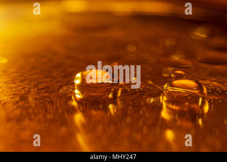 Oil drops and bubbles on a metal gear engine surface. Closeup photo ...
