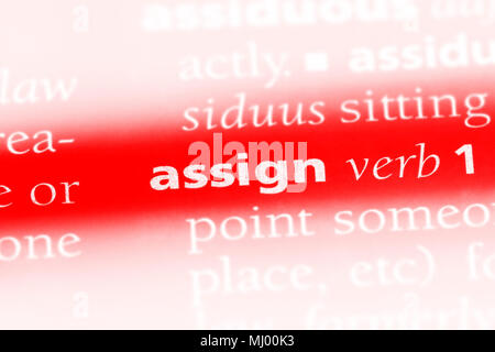 assign word in a dictionary. assign concept Stock Photo - Alamy