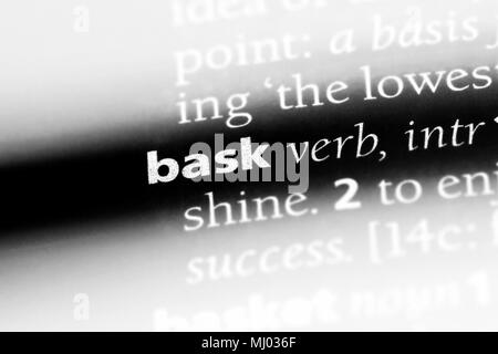 bask word in a dictionary. bask concept Stock Photo - Alamy