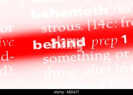 behind word in a dictionary. behind concept Stock Photo - Alamy