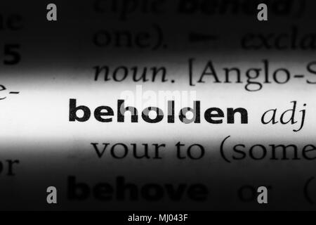 beholden word in a dictionary. beholden concept Stock Photo - Alamy
