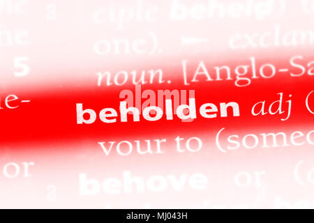 beholden word in a dictionary. beholden concept Stock Photo - Alamy