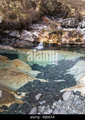 Rock pool eroded into Skye white marble slab in mountain stream bed of ...