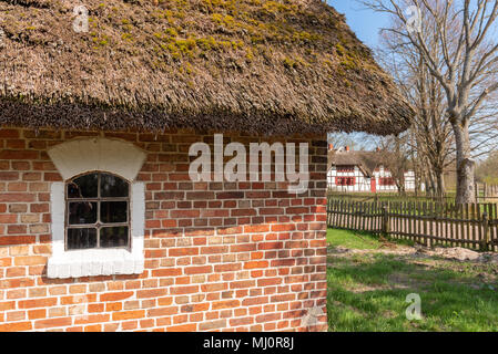 Typical traditional Polish country thatched house with white walls in ...