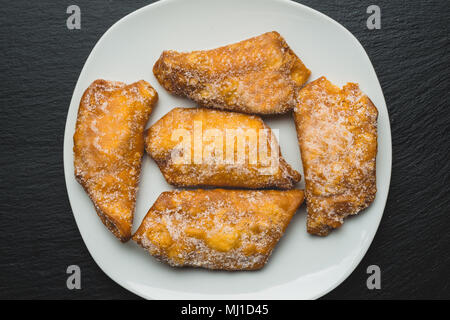Typical spanish sweets, Fritters with sugar or pestinos Stock Photo - Alamy