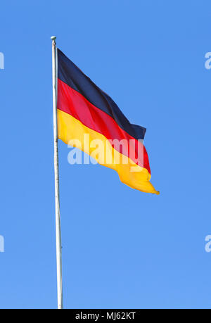 The National Flag of Germany flies on top of the Reichstag Building and ...