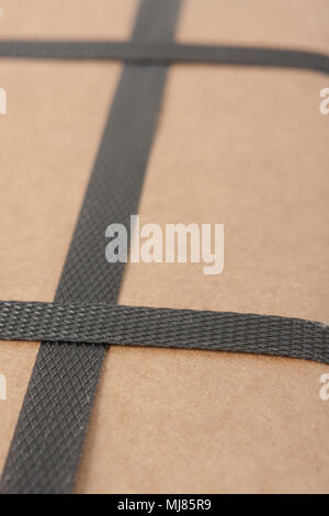 Cardboard box with plastic strapping Stock Photo - Alamy