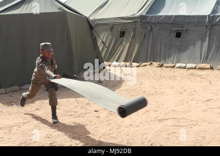 A soldier from the Tunisian Special Forces Group begins taking off his ...