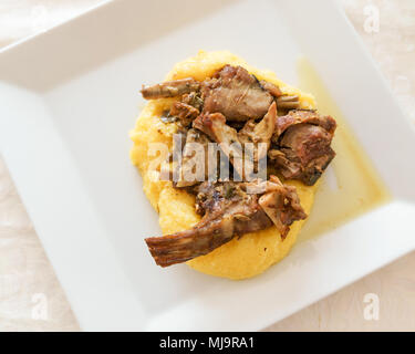 Typical italian food,polenta with Capretto( small goat meat) roasted ...